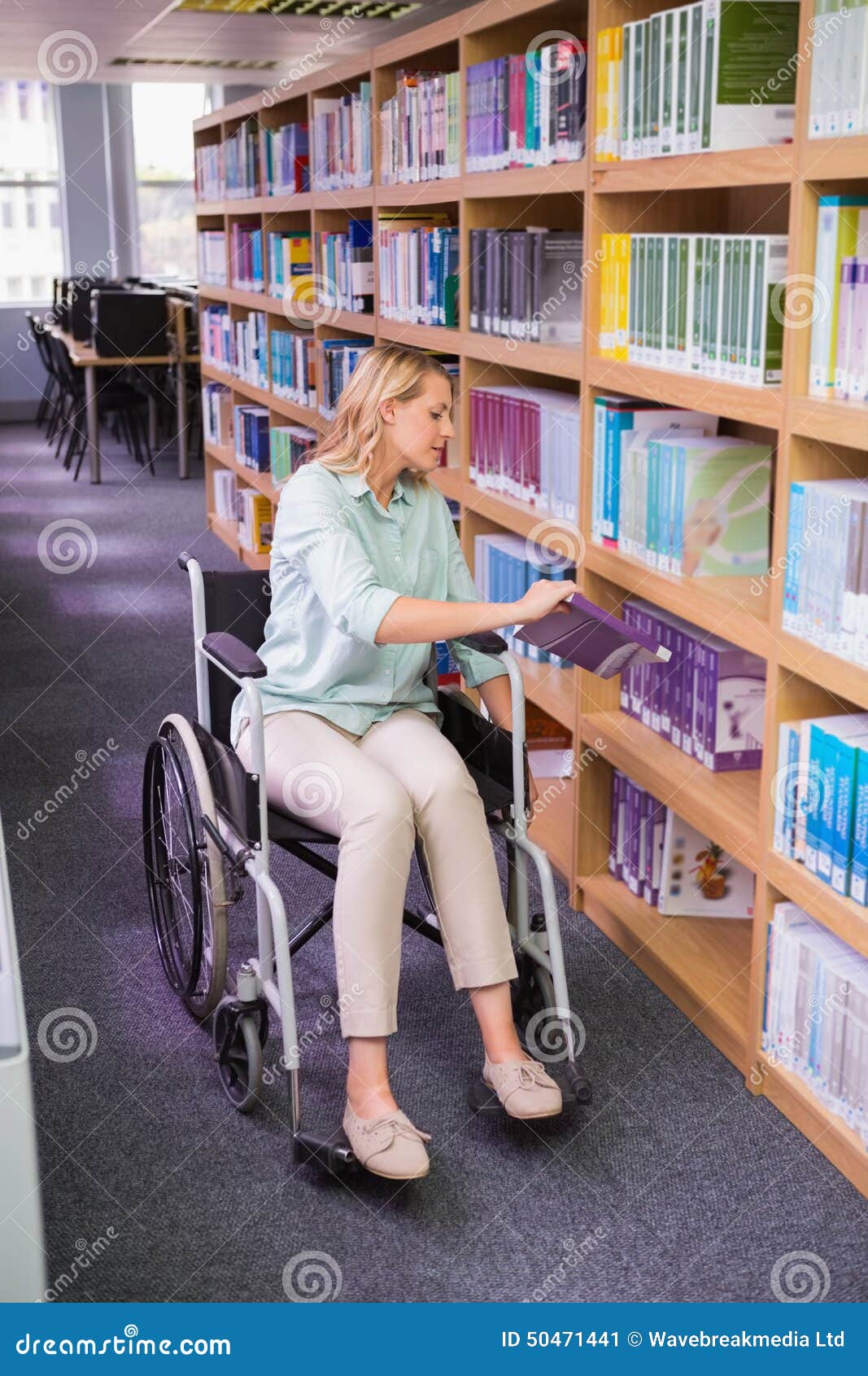 Smiling Disabled Student in Library Picking Book Stock Image - Image of ...