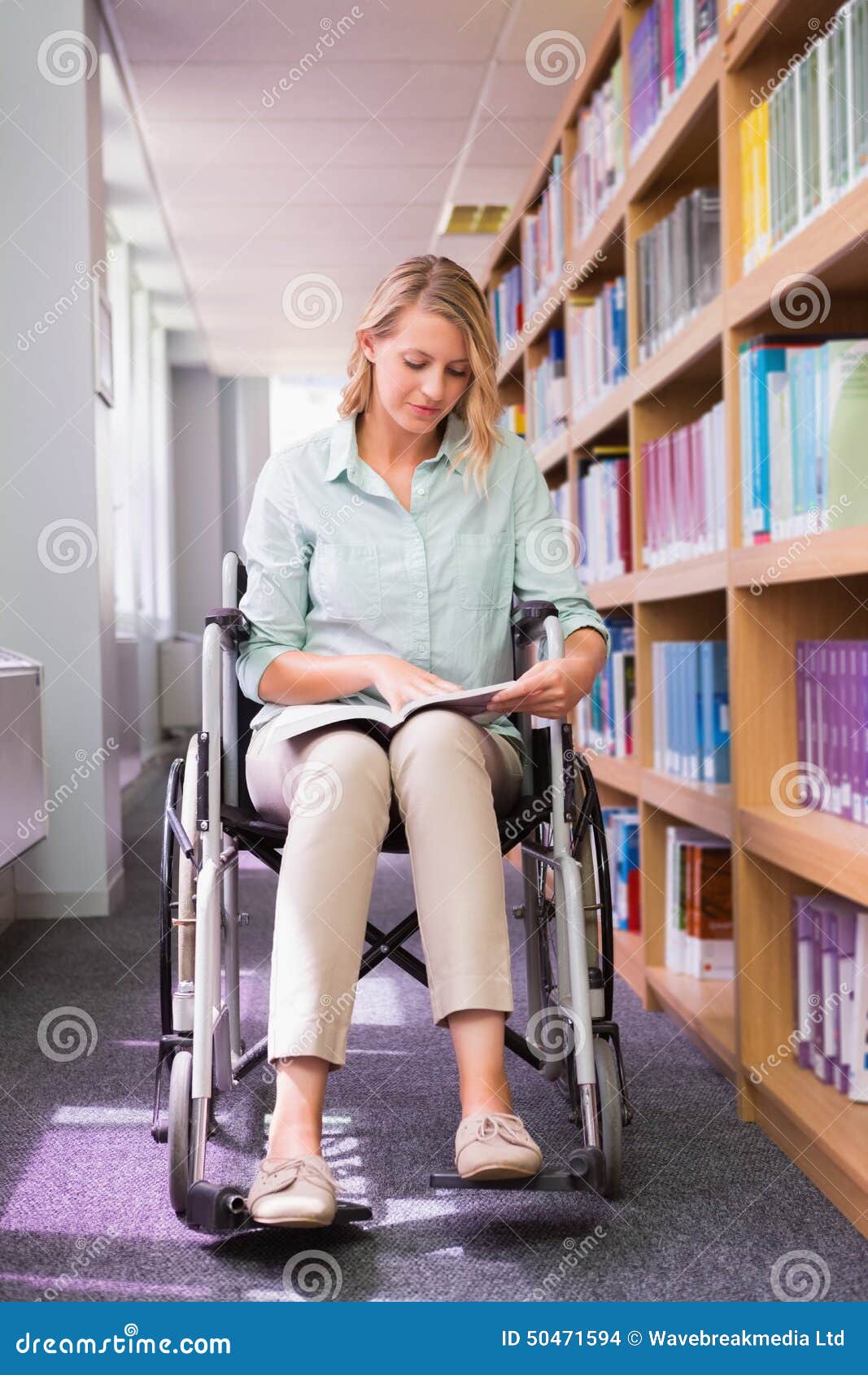 Smiling Disabled Student in Library Picking Book Stock Photo - Image of ...