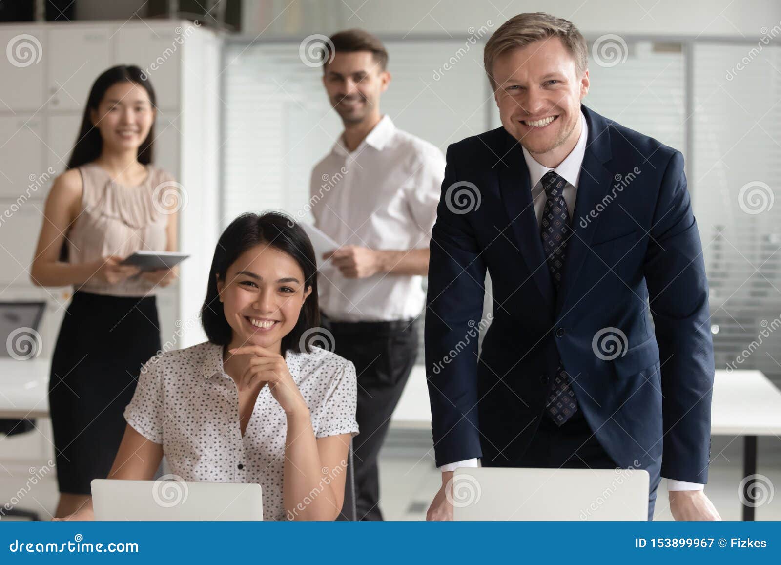 Smiling Diverse Business Leaders Posing with Computers and Team People ...
