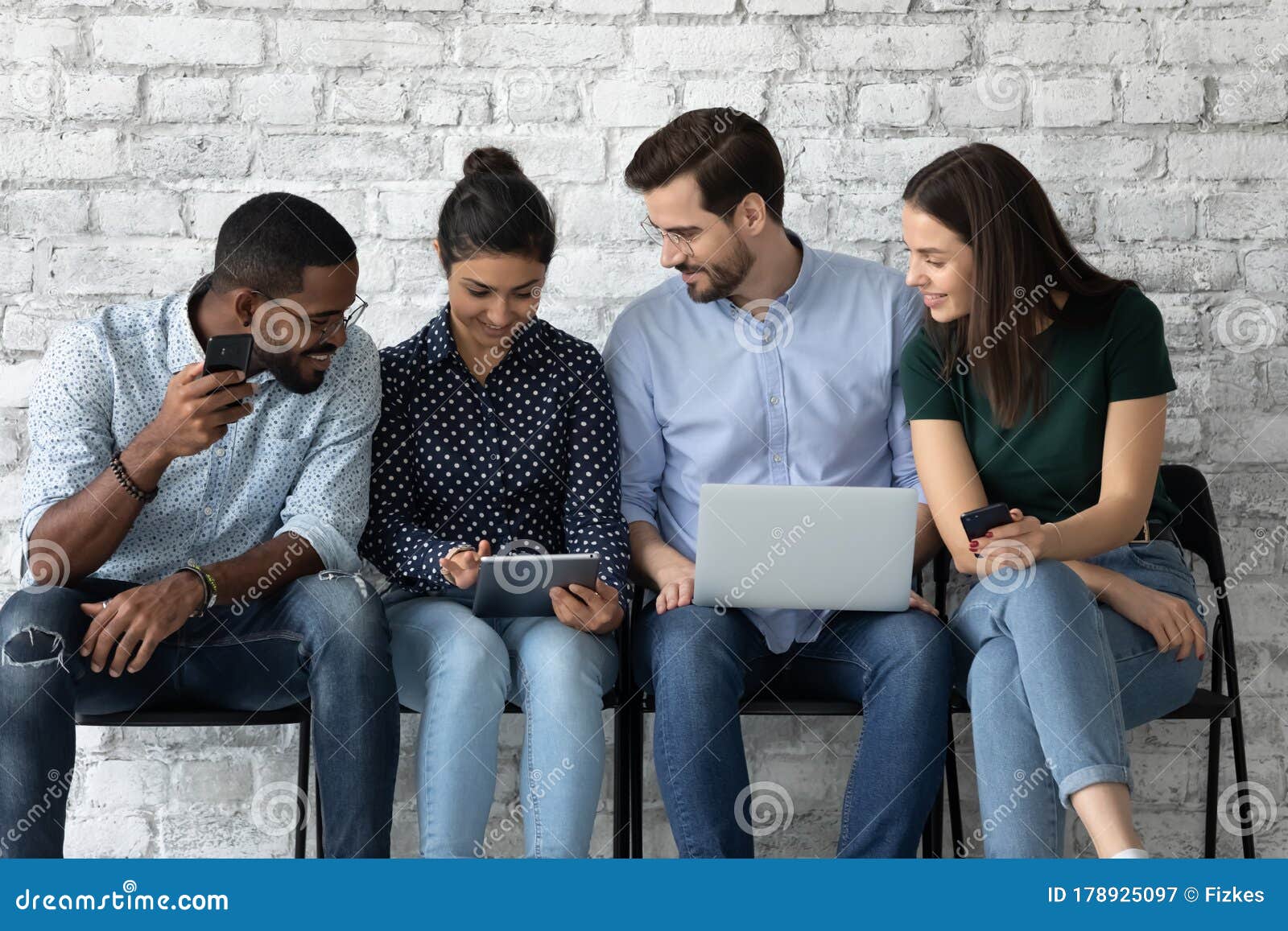 Smiling Diverse Candidates Prepare for Interview Using Gadgets Stock ...