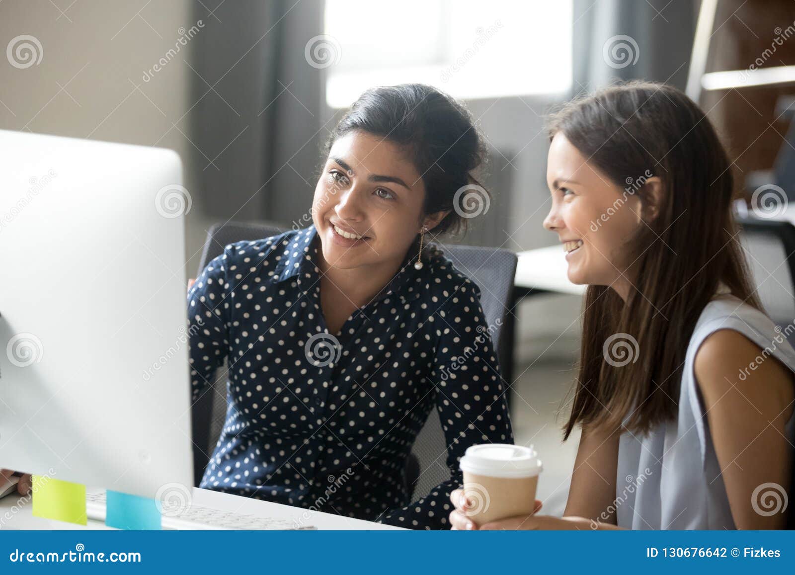 Smiling Diverse Female Interns Talking in Office Discussing Onli Stock ... Smiling Diverse Female Interns Talking in Office Discussing Onli Stock ...