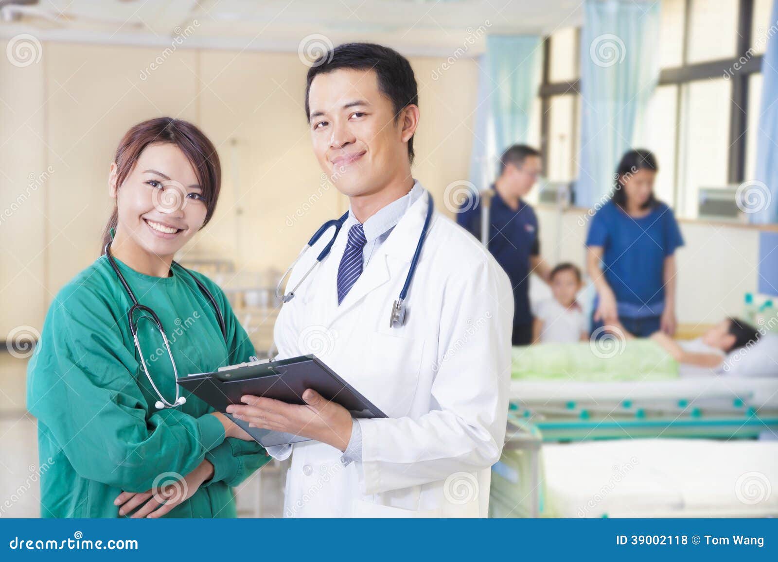 Smiling Doctor and Assistant with Patient Stock Photo - Image of ...