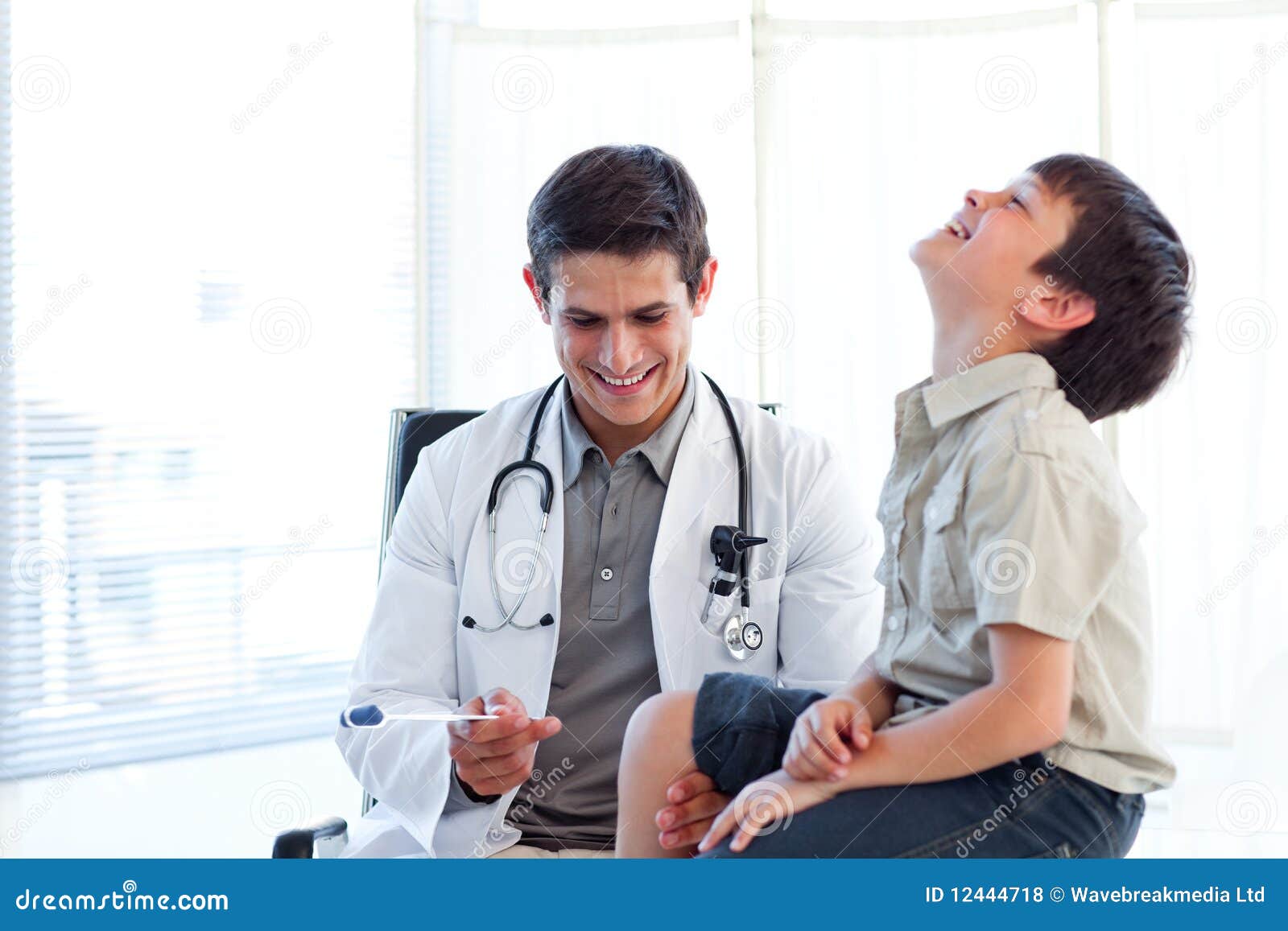 Smiling Doctor Checking a Child S Reflex Stock Photo - Image of ...