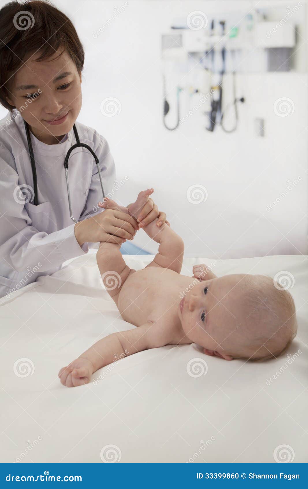 Smiling Doctor Examining a Baby in the Doctors Office Stock Photo ...