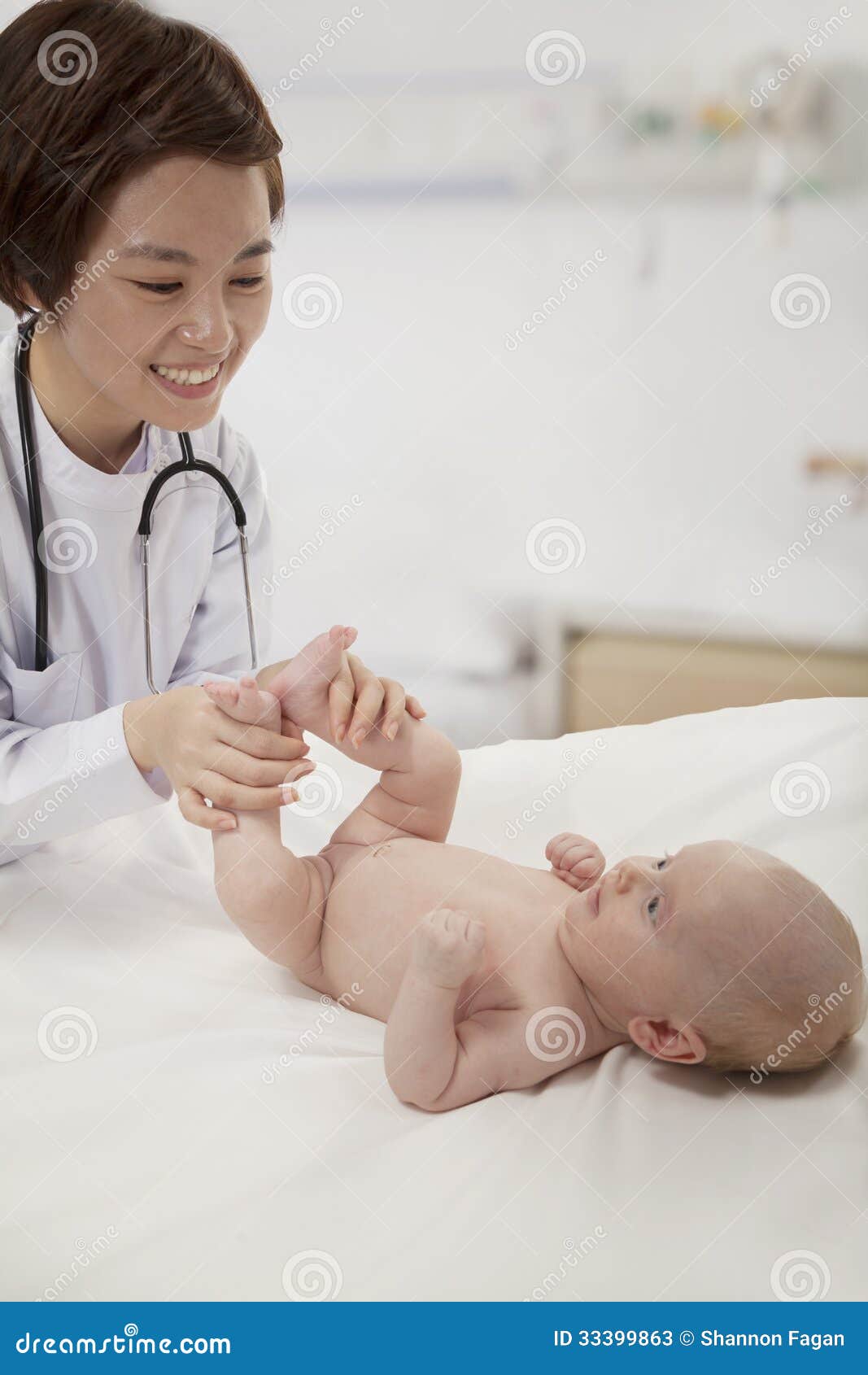Smiling Doctor Examining a Baby in the Doctors Office Stock Image ...