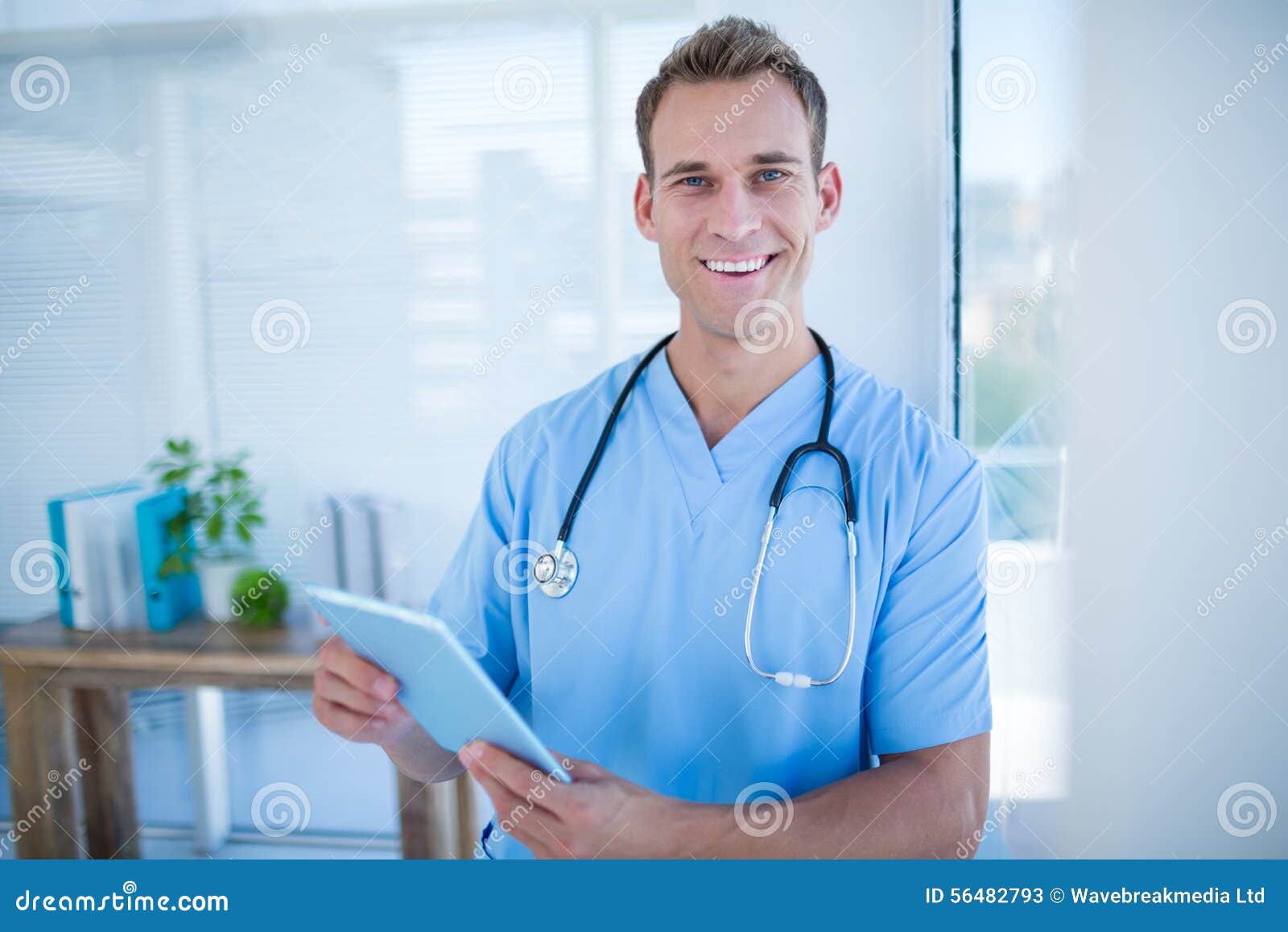 Smiling Doctor Holding His Tablet Stock Image - Image of hospital ...
