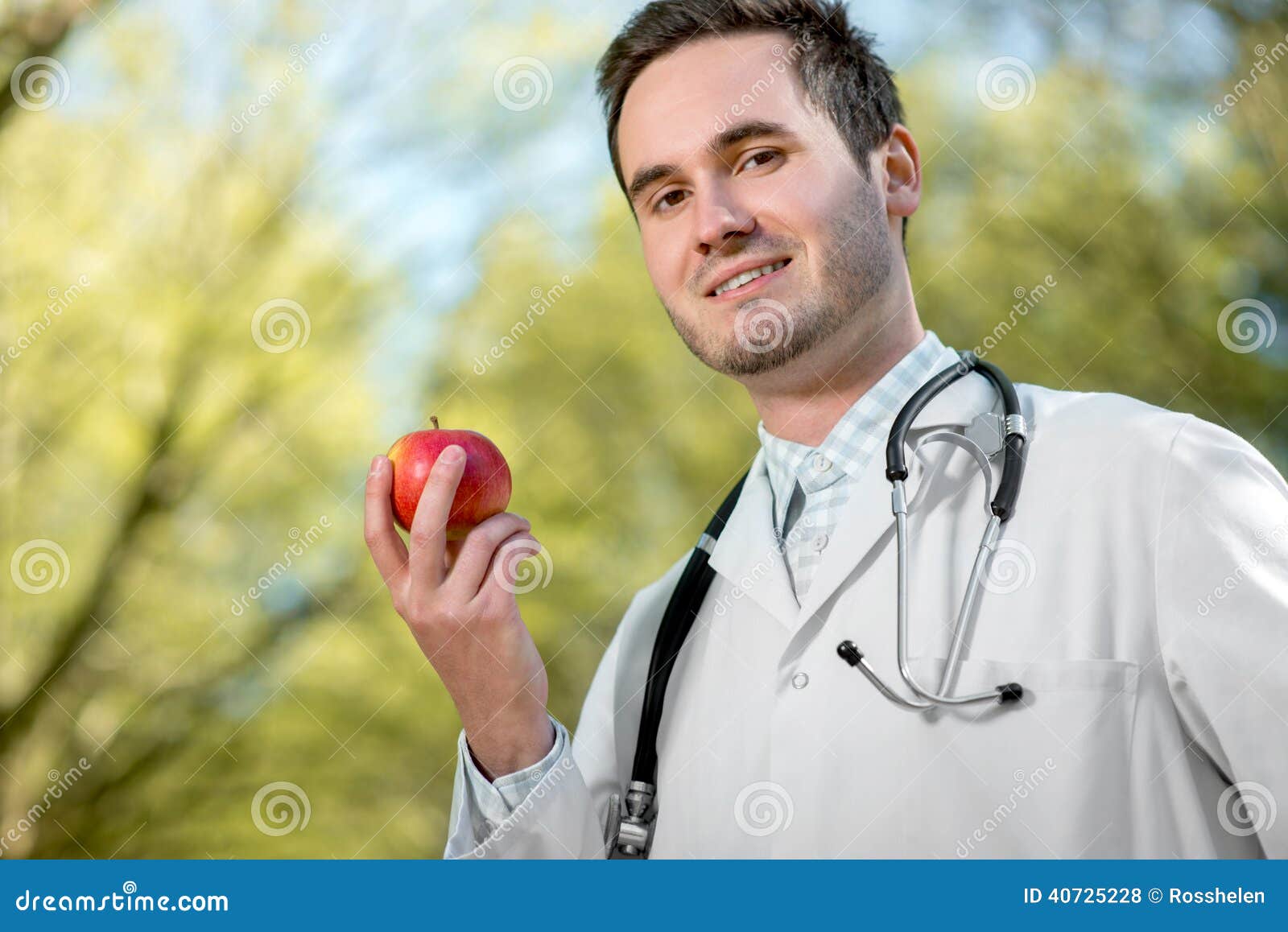 Smiling Doctor Keeping an Apple in Hand Stock Photo - Image of dentist ...