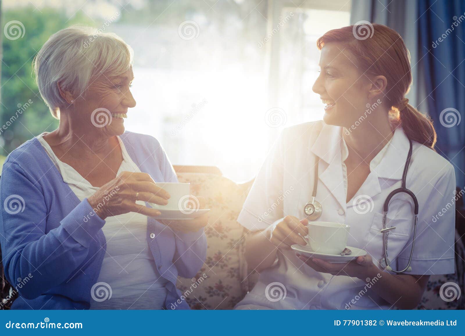 Smiling Doctor and Patient Talking while Having Tea Stock Photo - Image ...