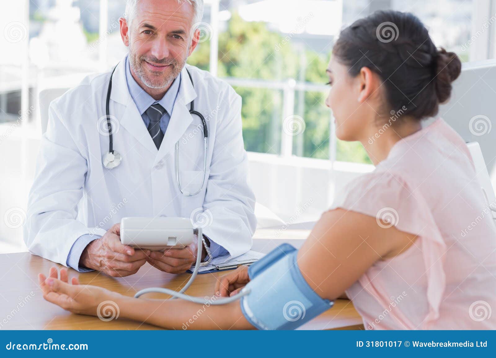 Smiling Doctor Taking the Heartbeat of a Patient Stock Image - Image of ...