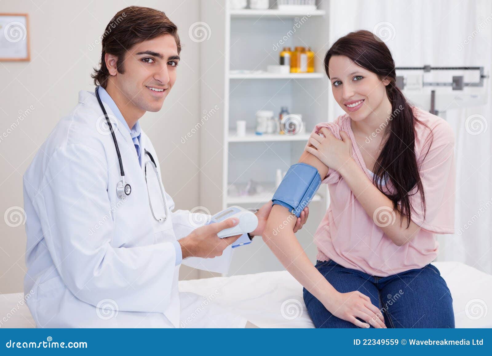 Smiling Doctor Taking Patients Blood Pressure Stock Image - Image of ...