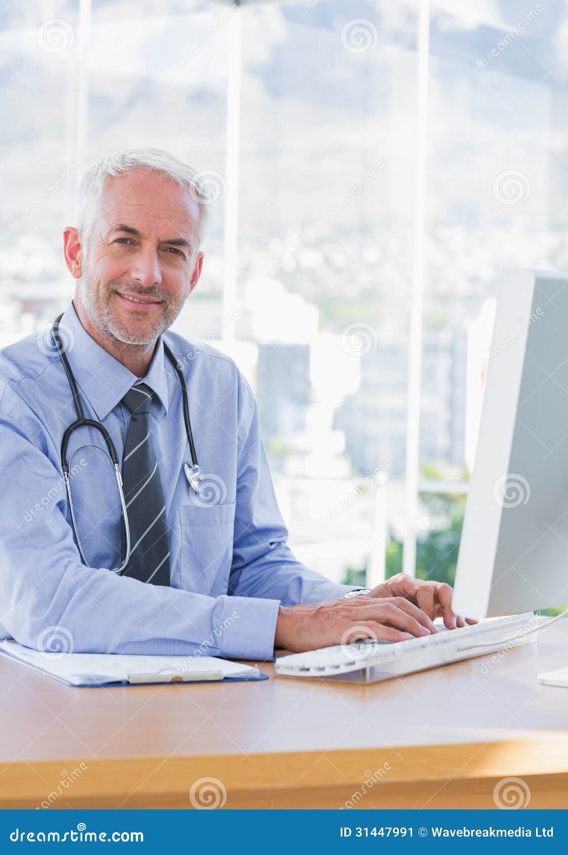 Smiling Doctor Typing on His Computer Stock Image - Image of medicine ...
