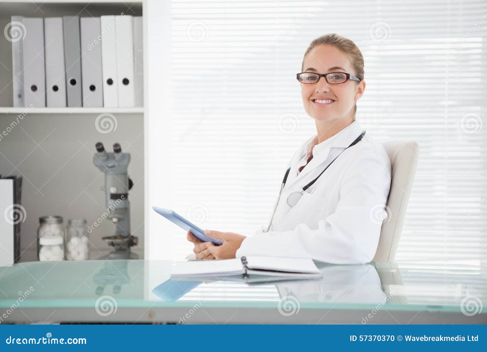 Smiling Doctor Using Her Tablet Stock Photo - Image of indoors ...