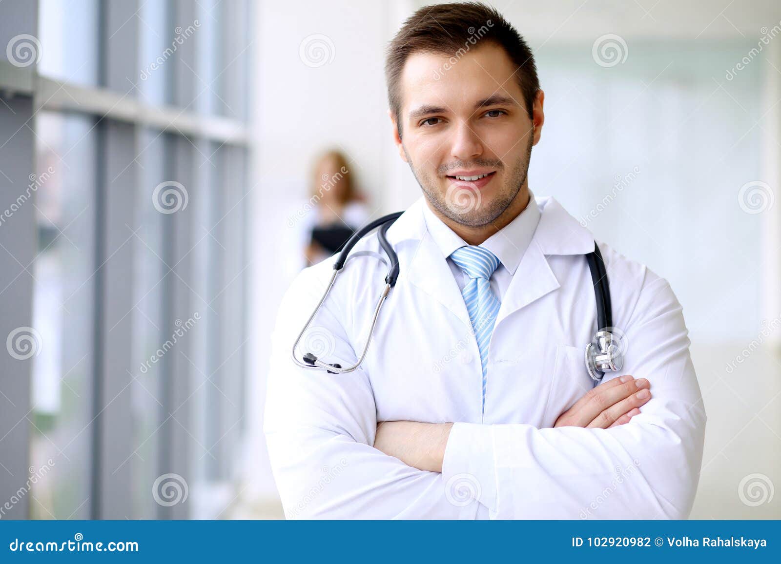 Smiling Doctor Waiting for His Team while Standing Upright Stock Photo ...
