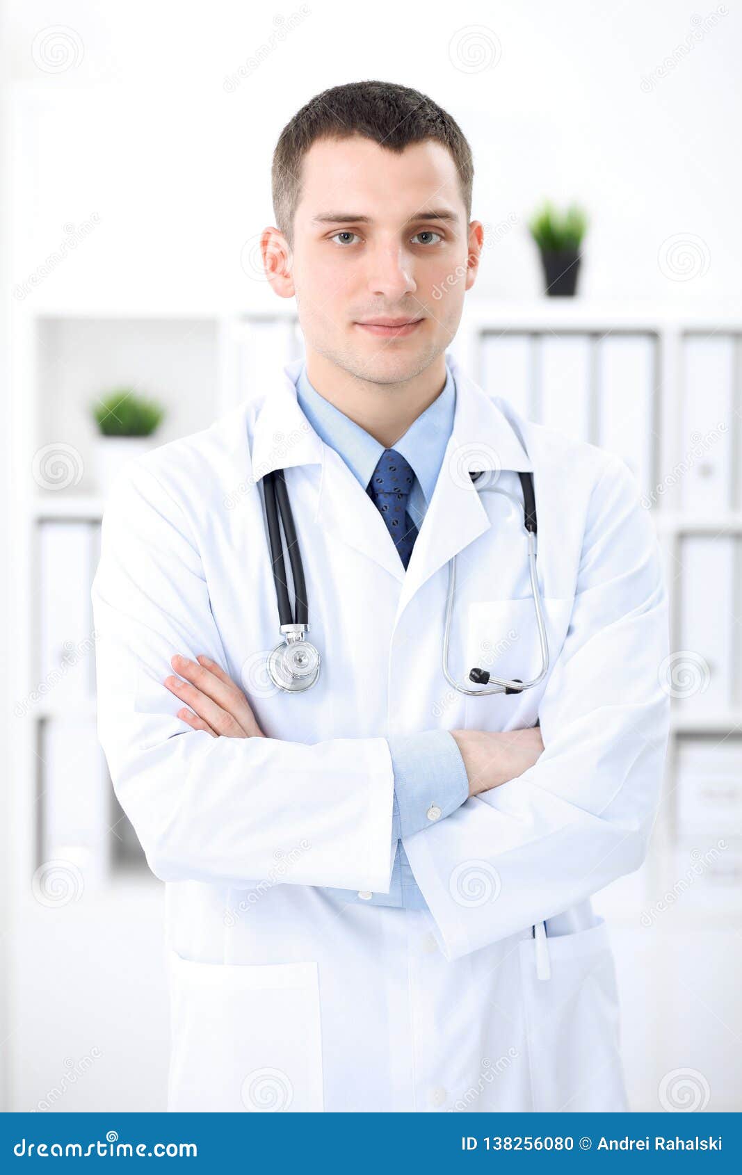 Smiling Doctor Waiting for His Team while Standing Upright Stock Photo ...