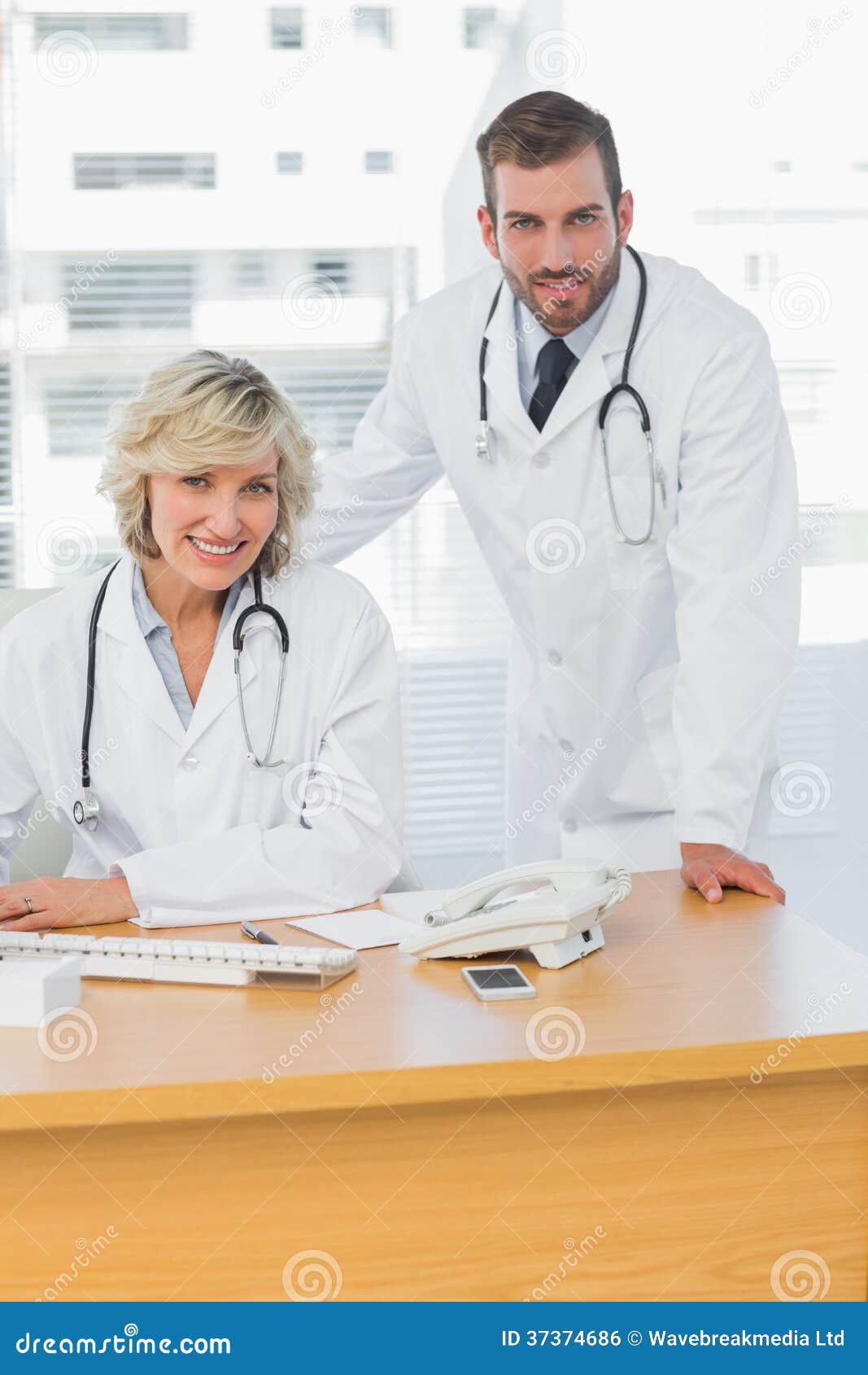Smiling Doctors with Computer at Medical Office Stock Photo - Image of ...