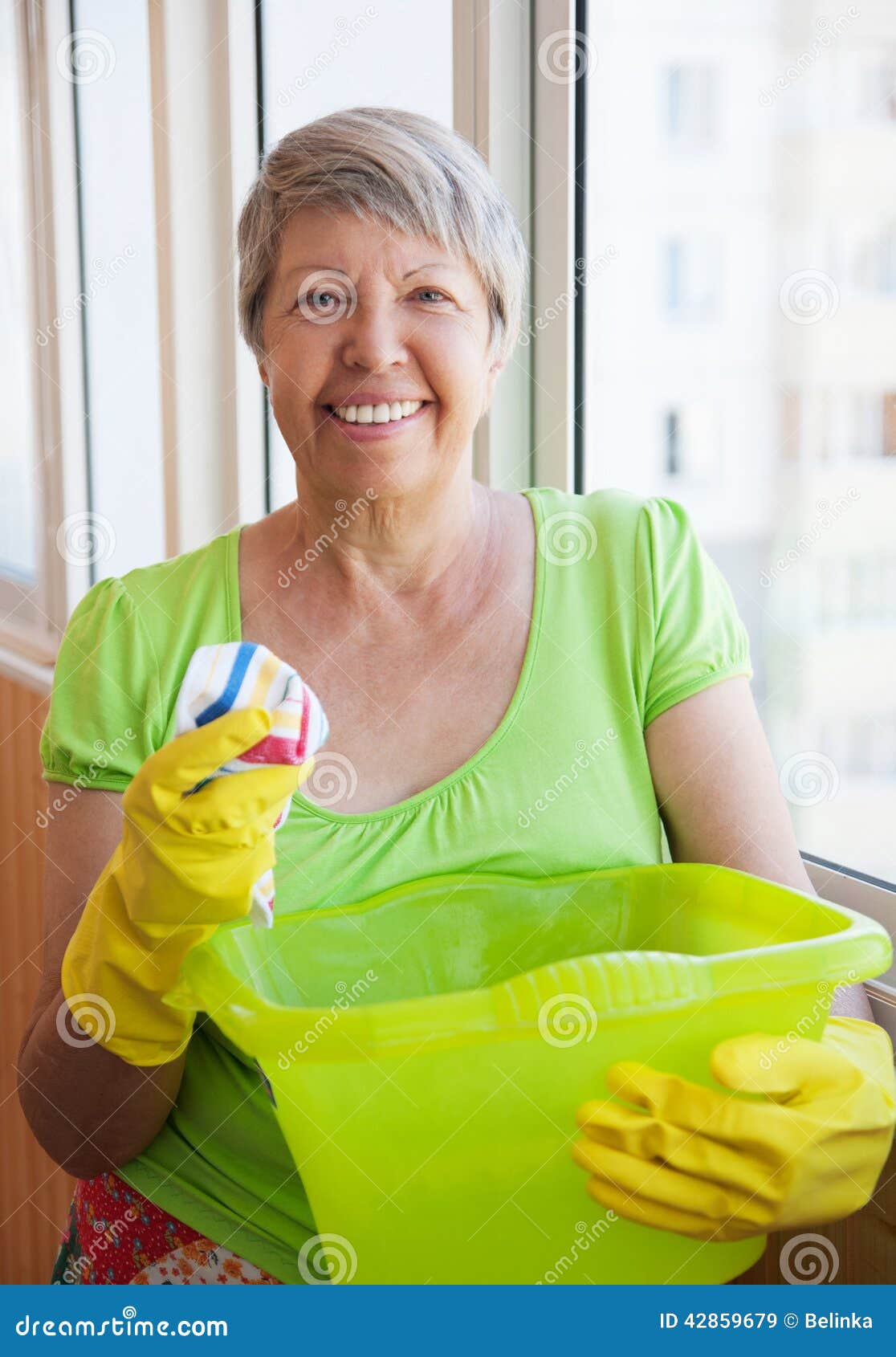 Smiling Elderly Woman Cleaning a Window Stock Image - Image of glass ...