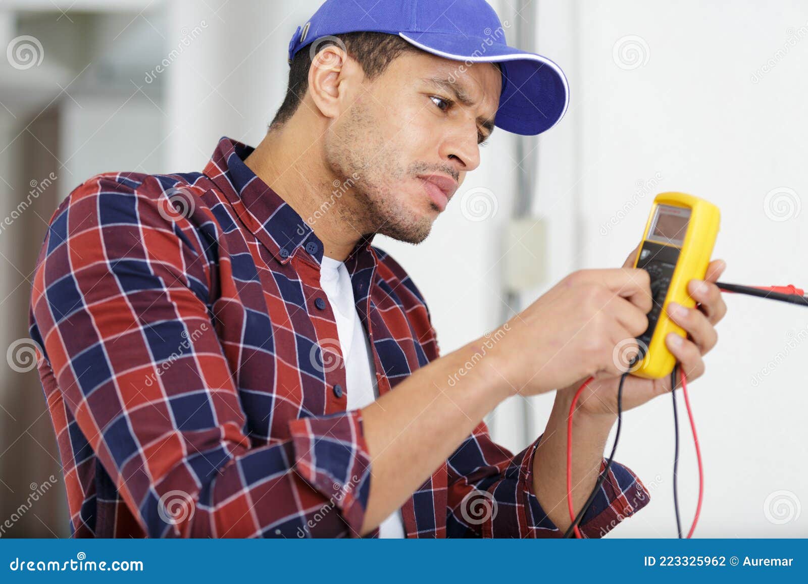 Smiling Electrician Using Multimeter on Electric Meter Stock Photo ...
