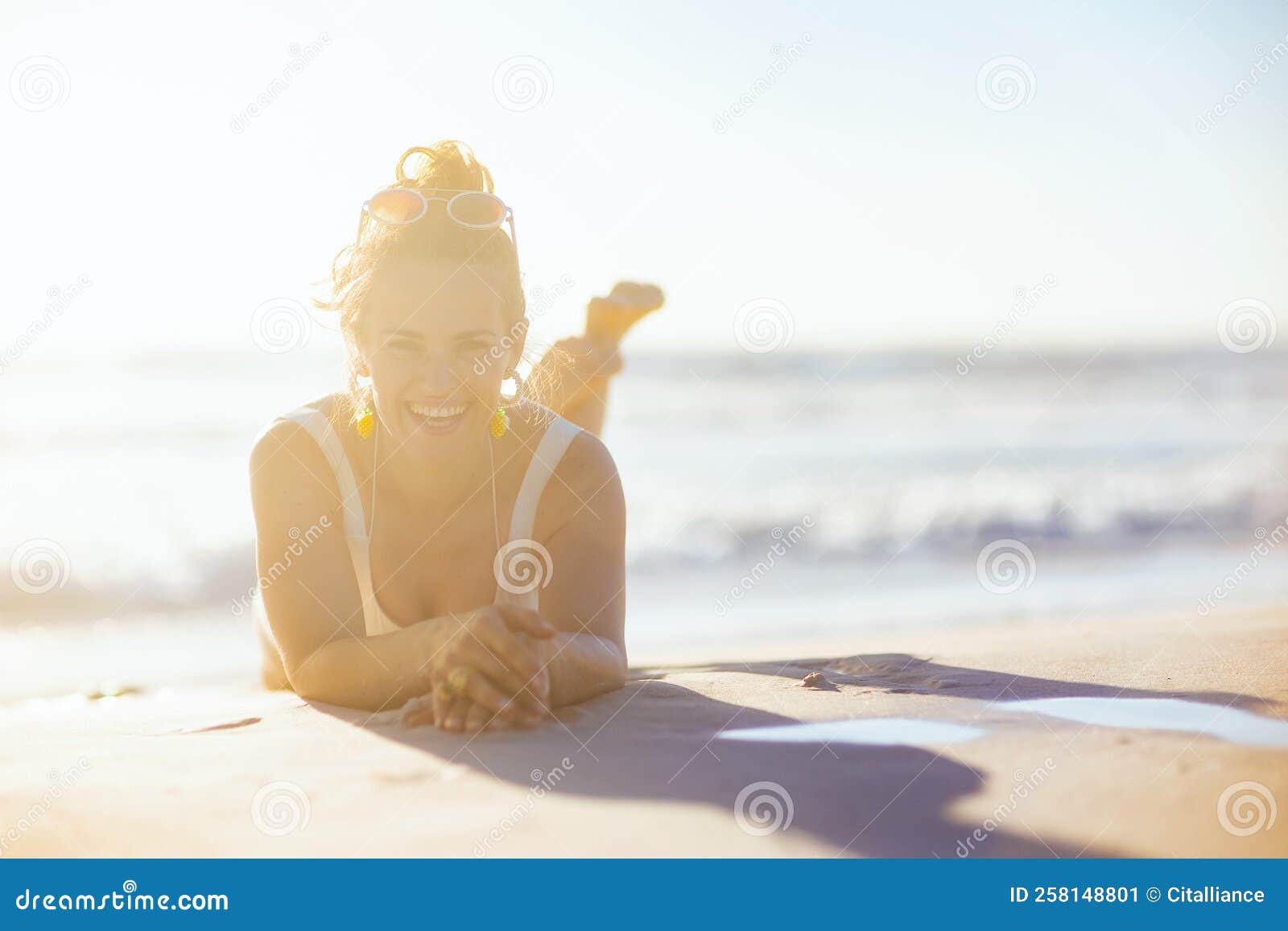 Smiling Elegant Woman in White Swimwear Laying at Beach Stock Image ... Smiling Elegant Woman in White Swimwear Laying at Beach Stock Image ...