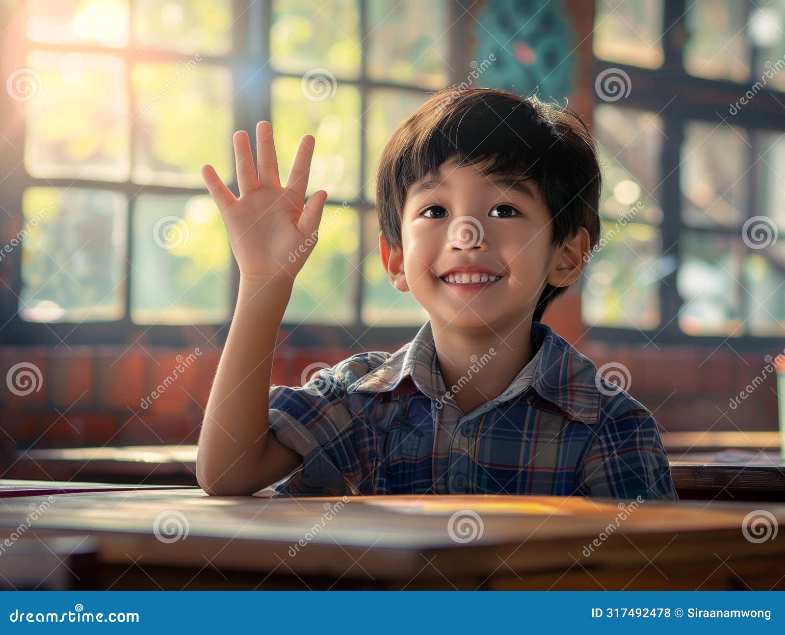Smiling Elementary Asian Student Raising His Hand To Answer a Question ...