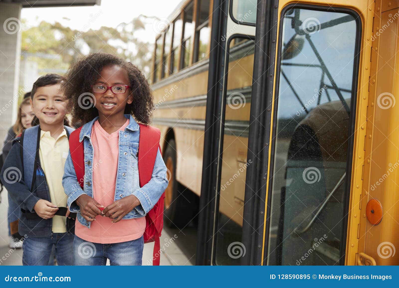 Smiling Elementary School Kids Queueing for the School Bus Stock Image ...