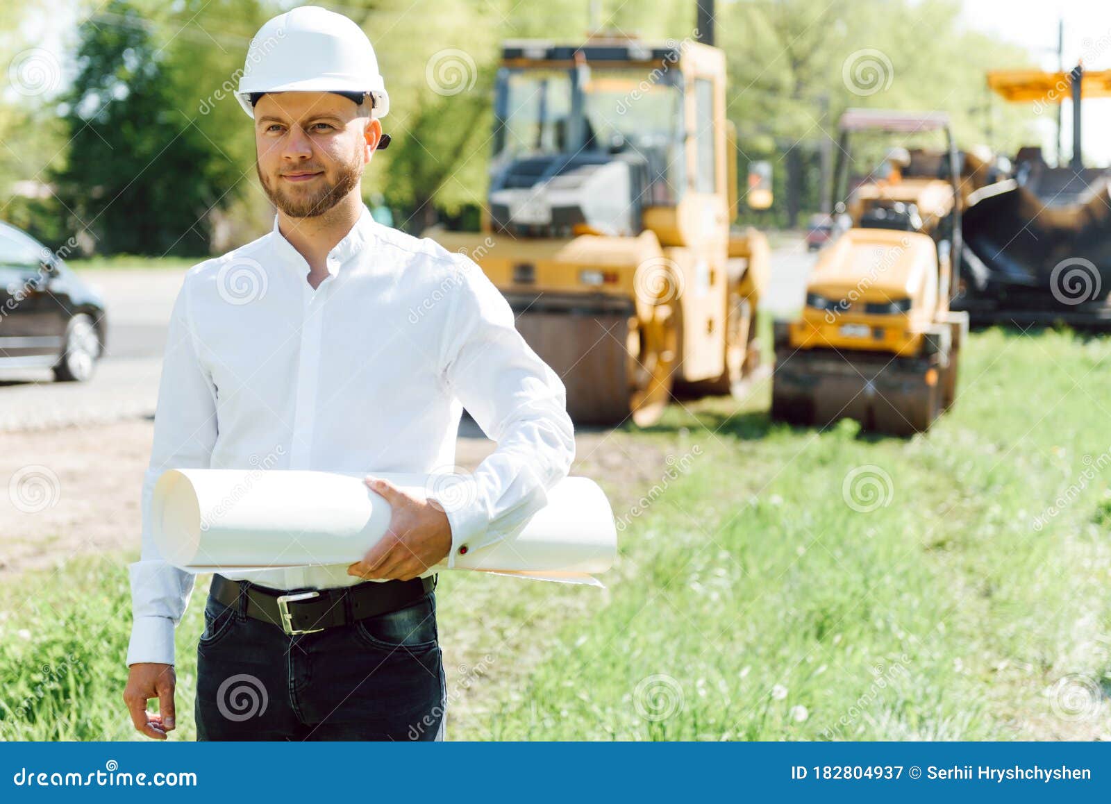Smiling Engineer with Helmet Standing in Front of Excavator on Road ...