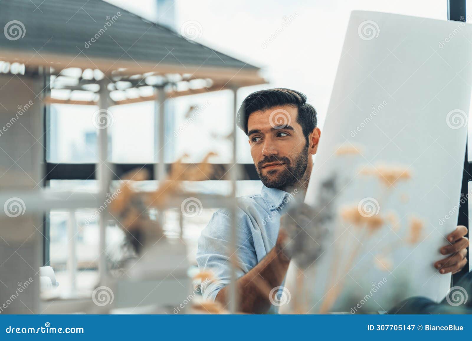 Smiling Engineer Looking Project Plan while Design House Model. Office ...