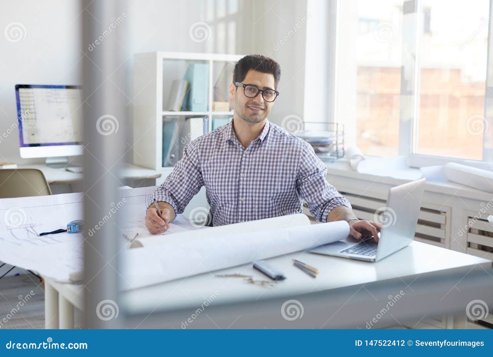 Smiling Engineer at Workplace Stock Photo - Image of blueprint, indian ...