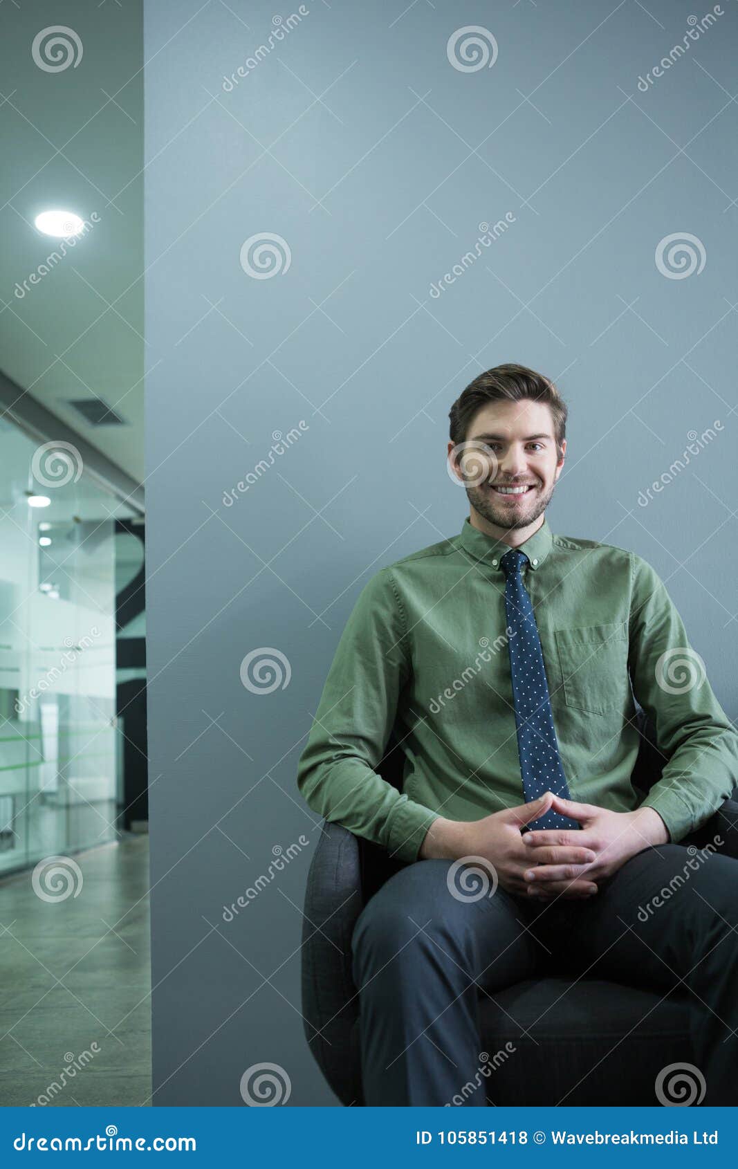 Smiling Executive Sitting on Chair in Waiting Area Stock Photo - Image ...