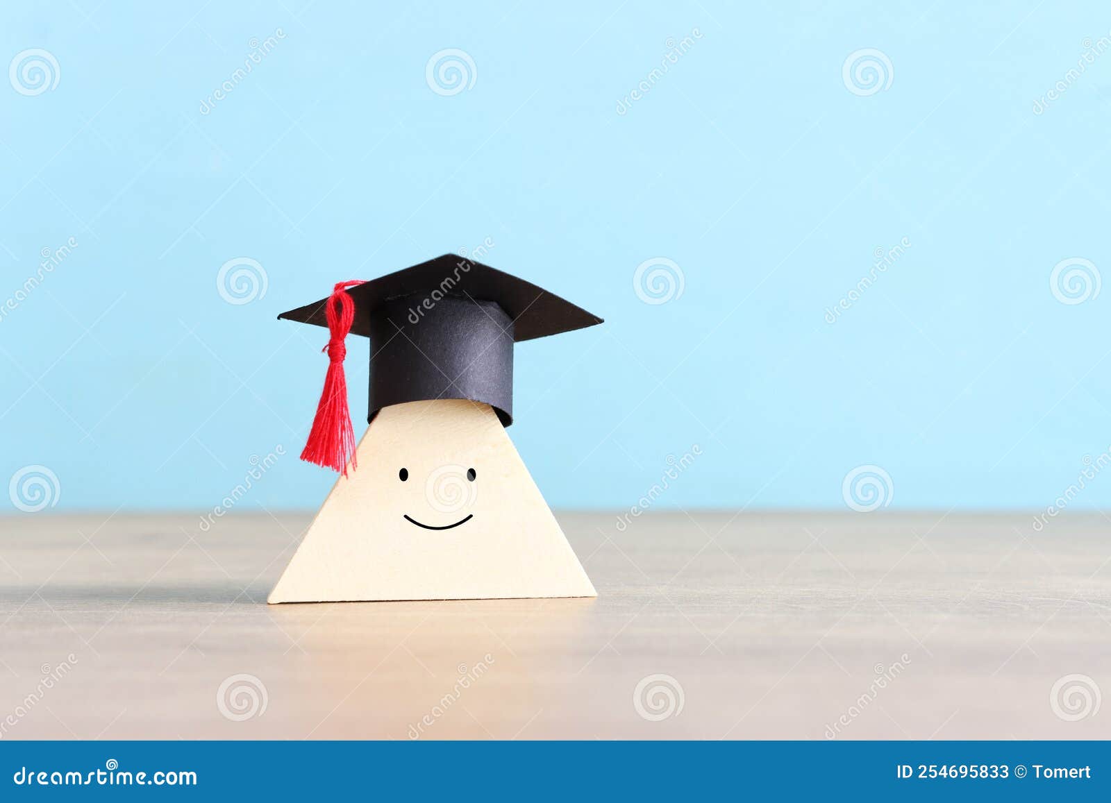 A Smiling Face with a Graduation Cap on Wooden Cube. Concept of ...