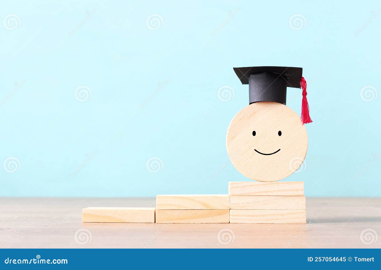 A Smiling Face with a Graduation Cap on Wooden Cube. Concept of ...