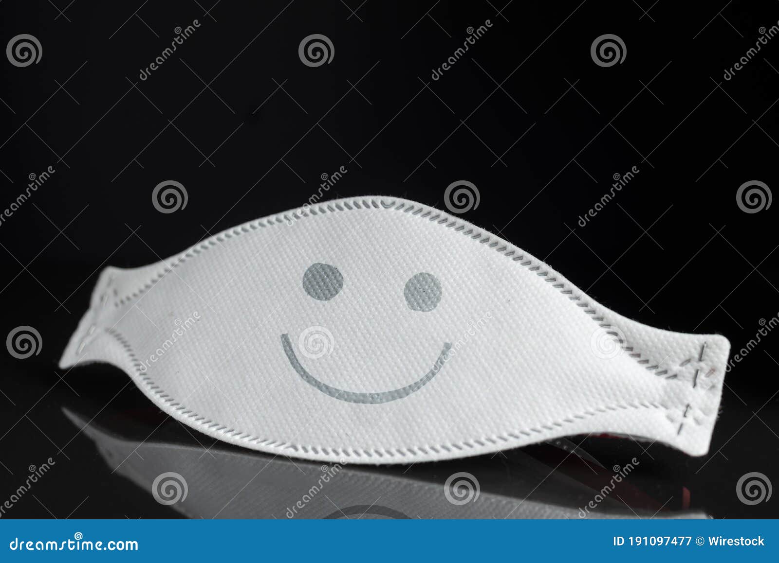 Smiling Face on a White Protective Face Mask on a Black Background ...