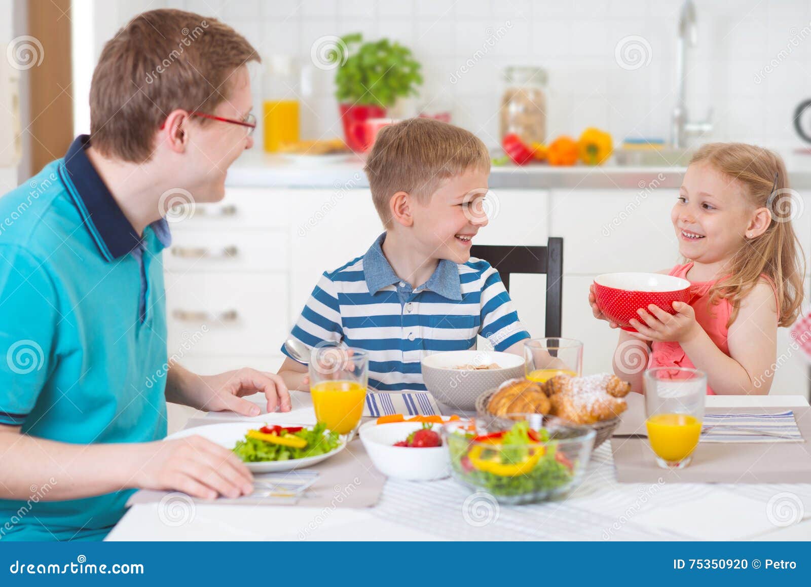Smiling Family Eating Breakfast in Kitchen Stock Photo - Image of ...