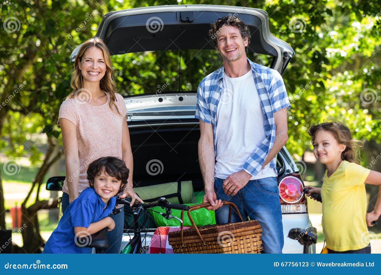 Smiling Family in Front of a Car Stock Image - Image of green, bikes ...