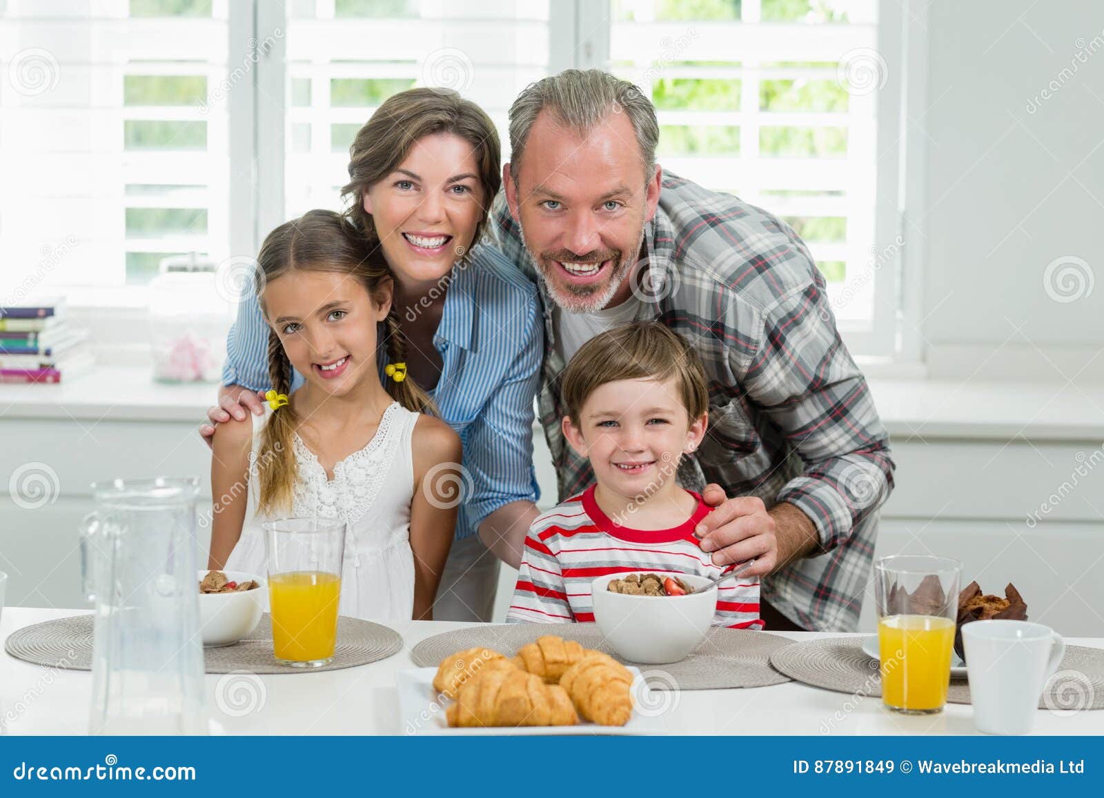 Smiling Family Having Breakfast in the Kitchen Stock Image - Image of ...
