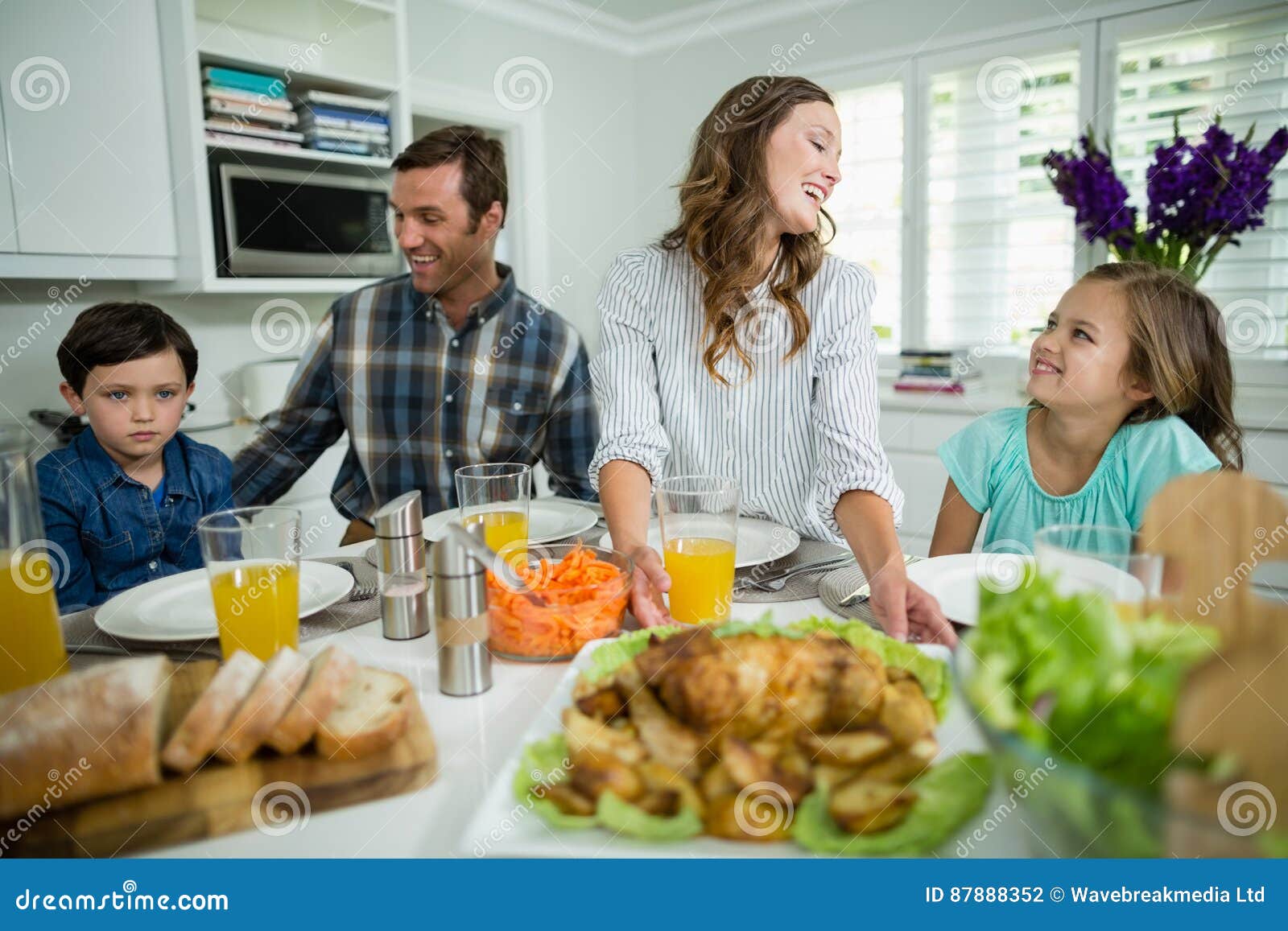 Smiling Family Having Lunch Together on Dining Table Stock Photo ...