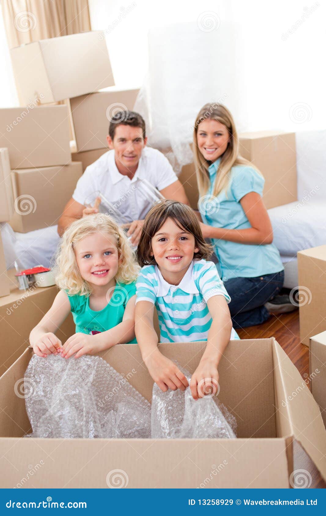Smiling Family Packing Boxes Stock Image - Image of father, boxes: 13258929