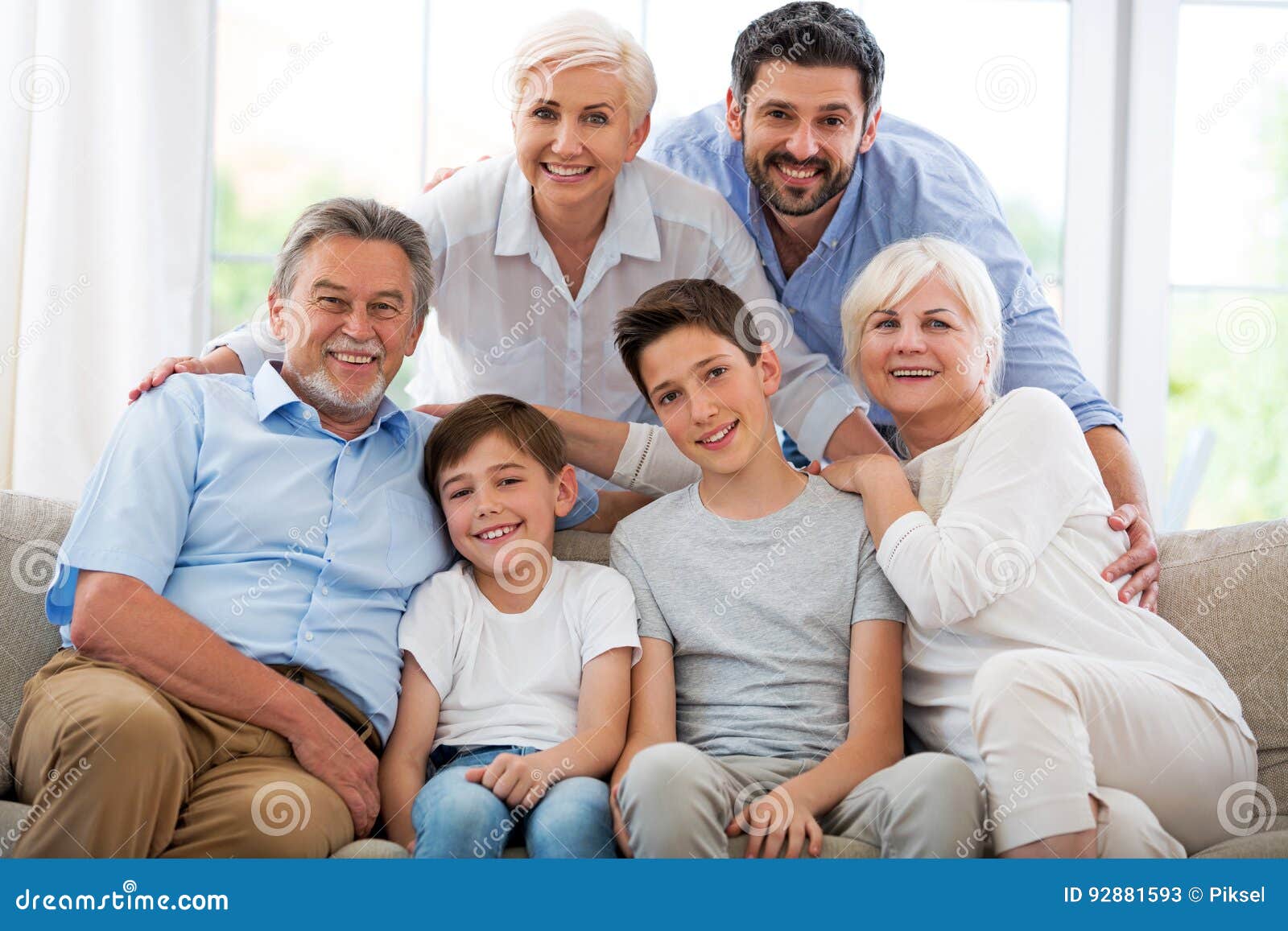Smiling family on sofa stock image. Image of grandmother - 92881593