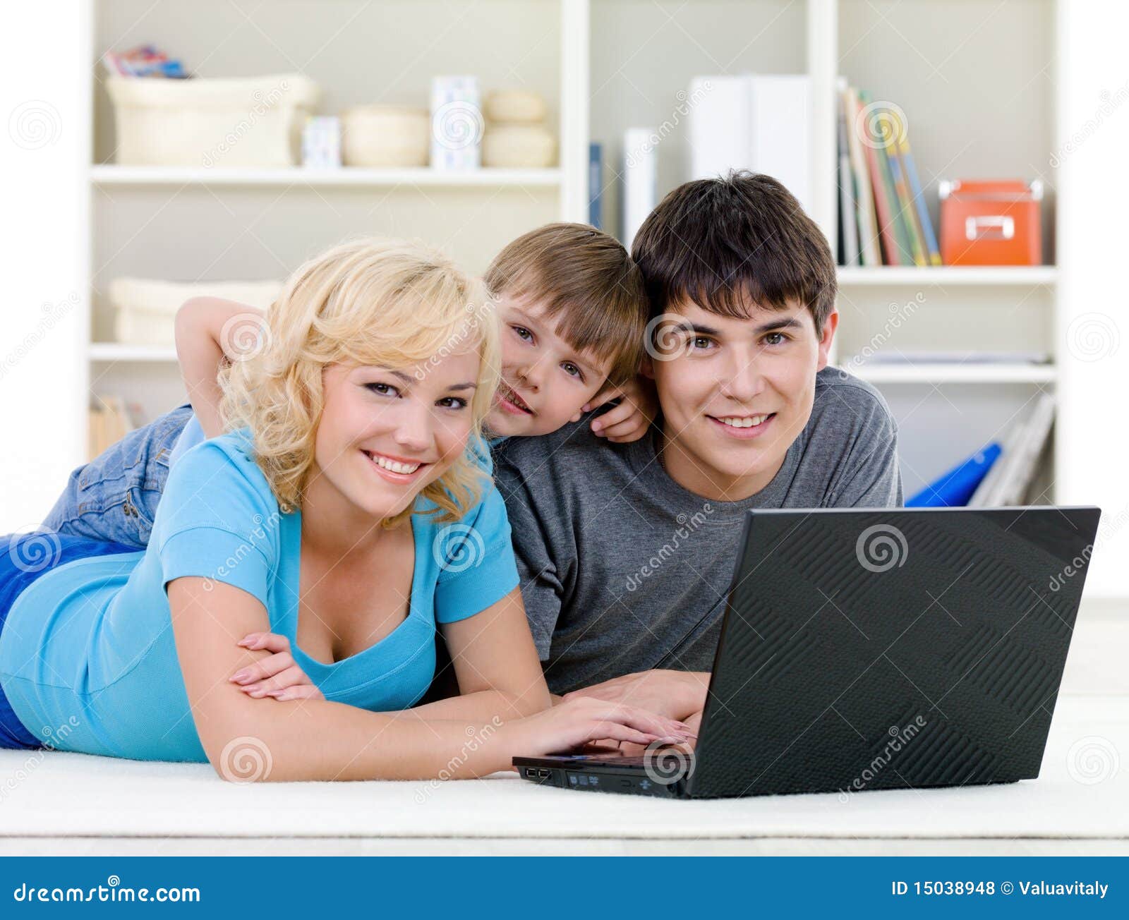 Smiling Family Using Laptop Stock Photo - Image of casual, family: 15038948
