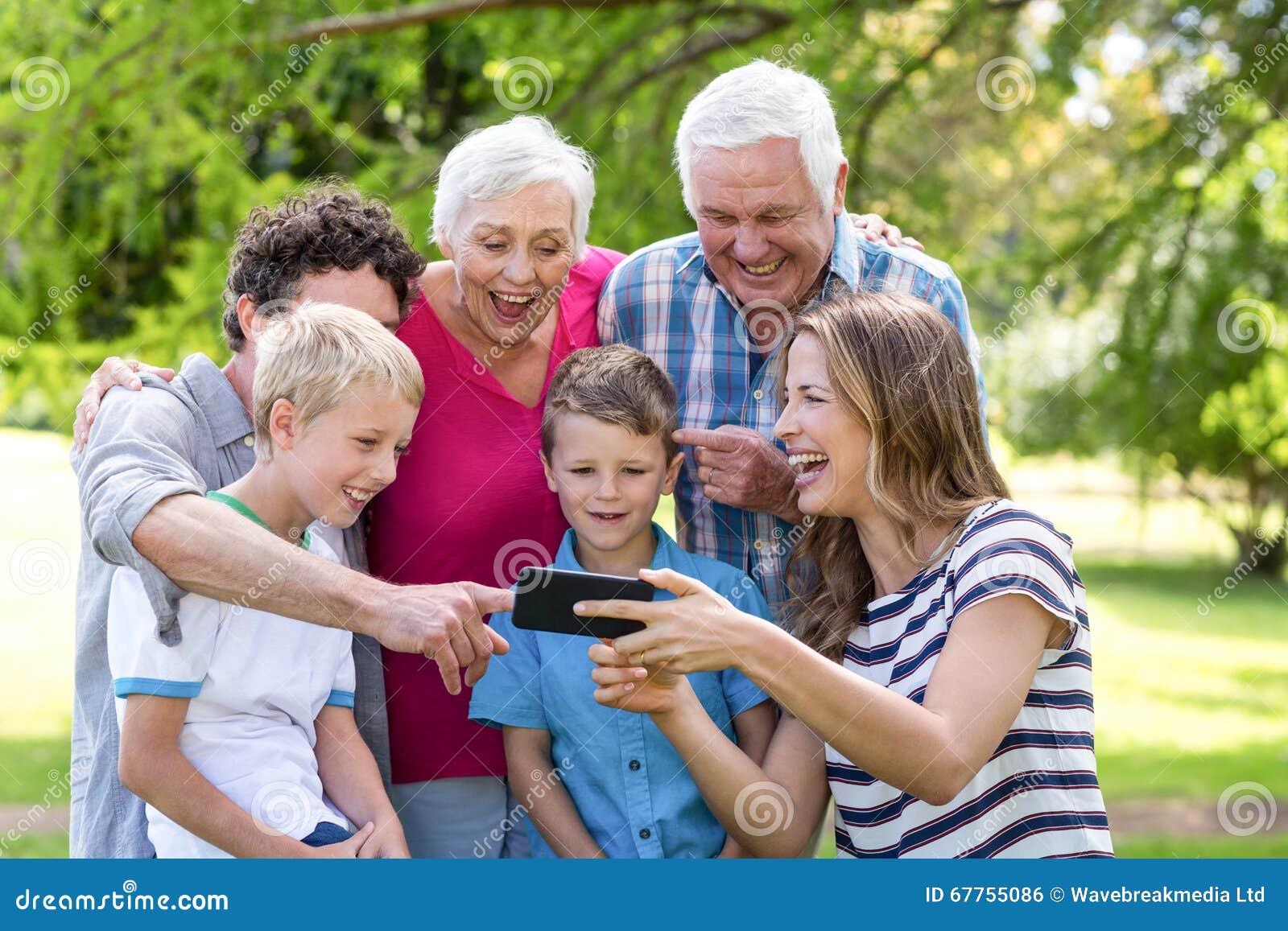 Smiling Family Using Smartphone Stock Photo - Image of finger, mobile ...