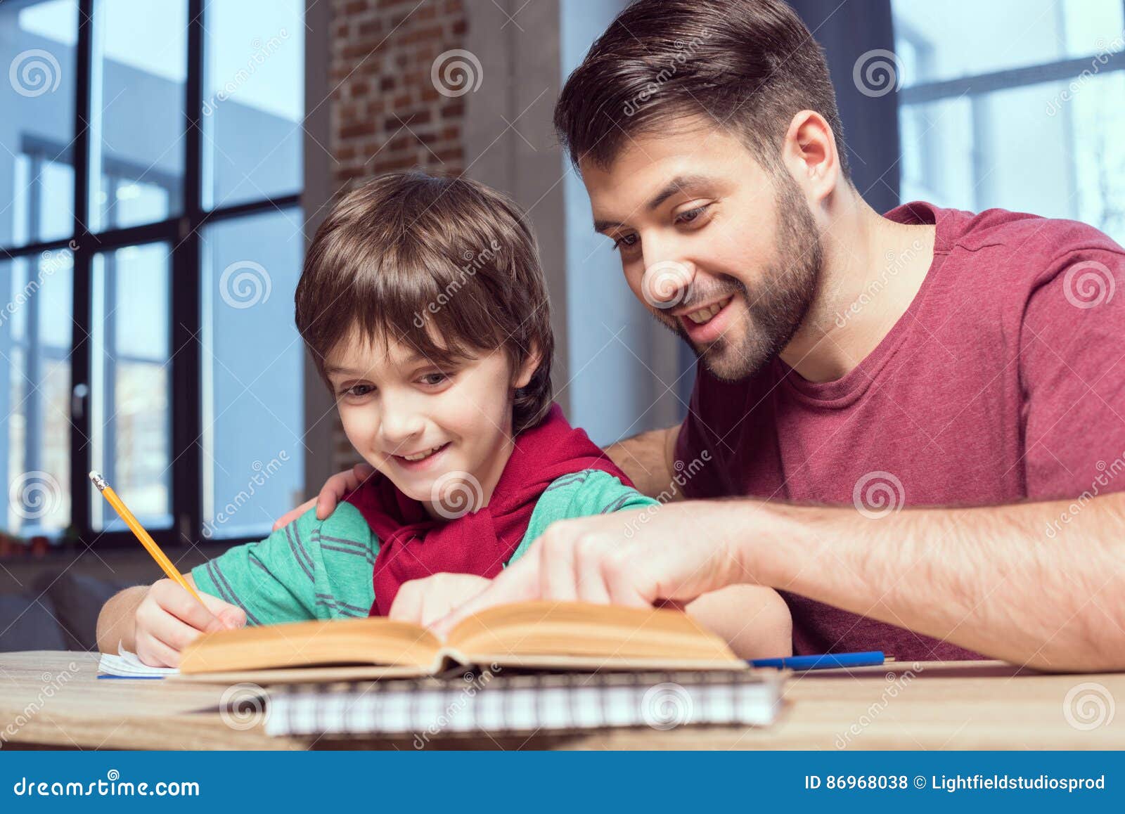Smiling Father Helping Son with Homework Stock Photo - Image of writing ...