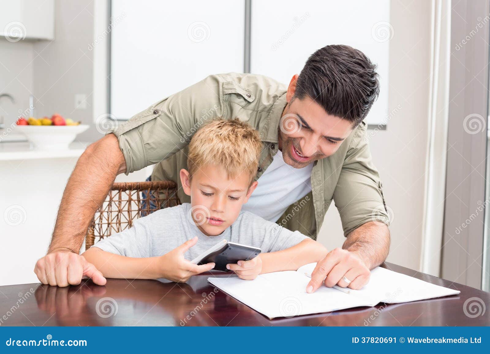 Smiling Father Helping Son with Math Homework at Table Stock Image ...