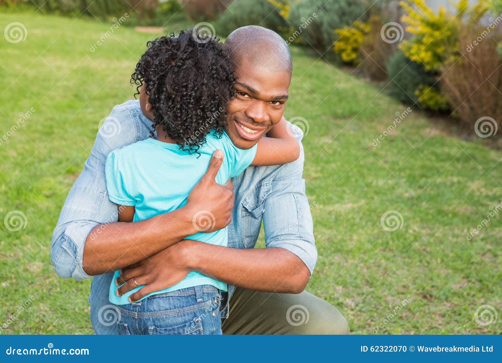 Smiling Father Hugging His Daughter Stock Photo - Image of grass ...
