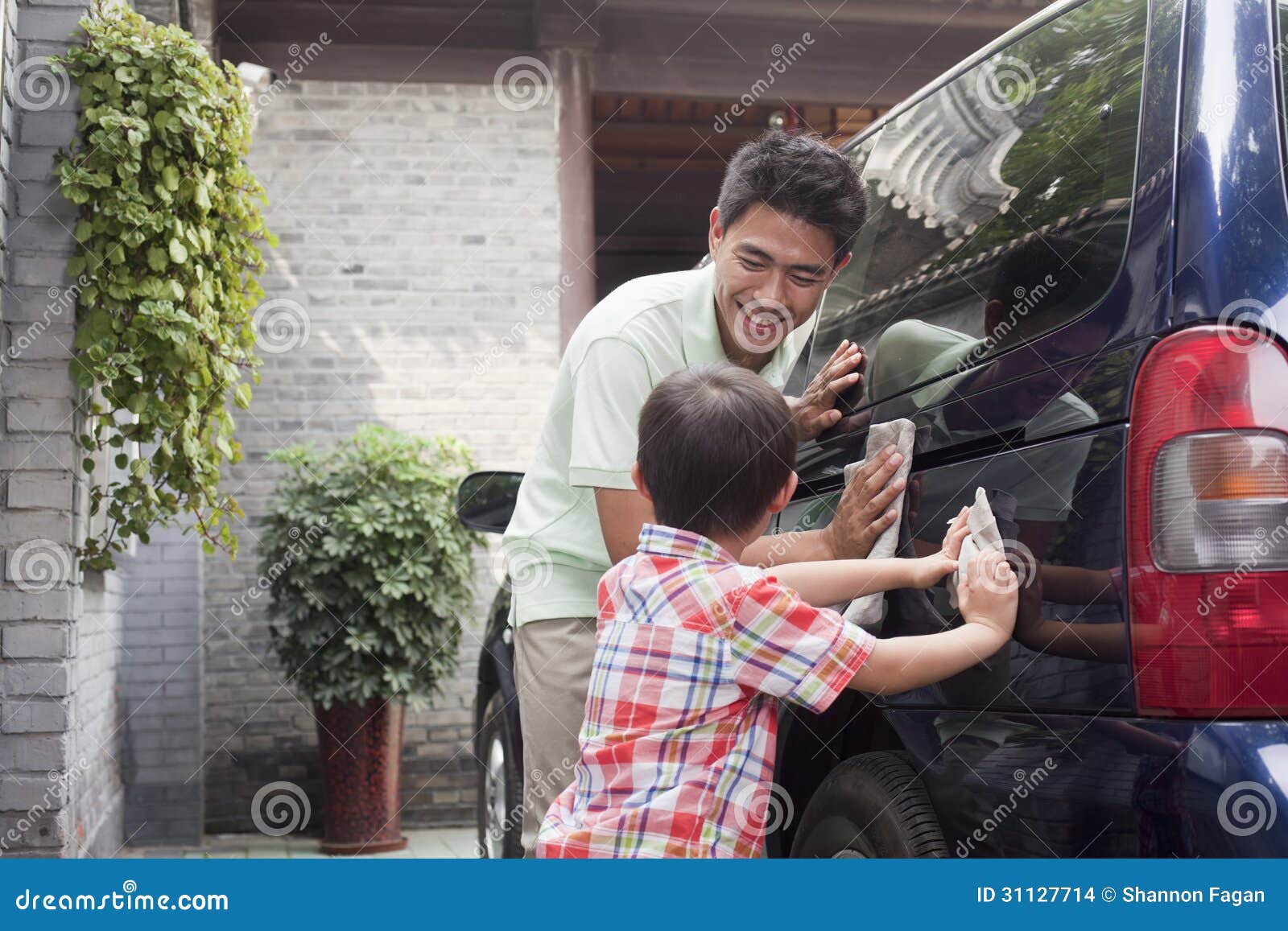 Smiling Father and Son Clean Their Minivan Together Stock Photo - Image ...