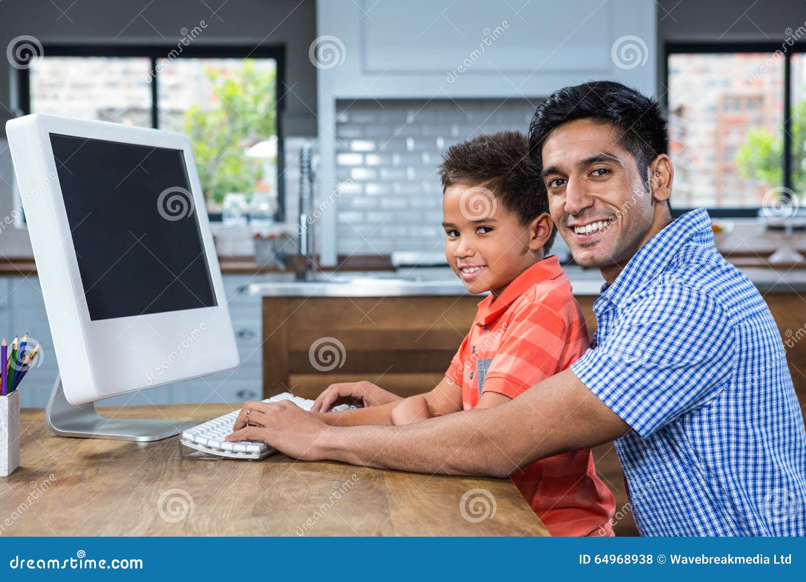 Smiling Father Using Computer with His Son Stock Photo - Image of ...