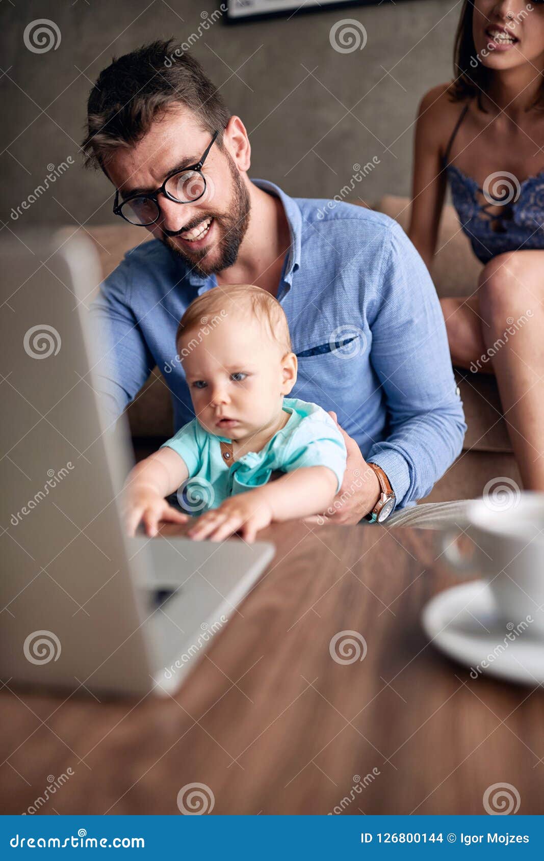 Smiling Father Working with Computer while Looking after His Baby Son ...