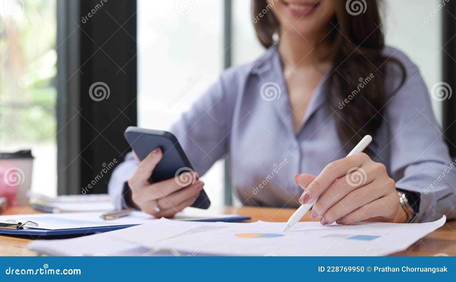 Female Accountant Holding Smart Phone and Analyzing Financial Document ...
