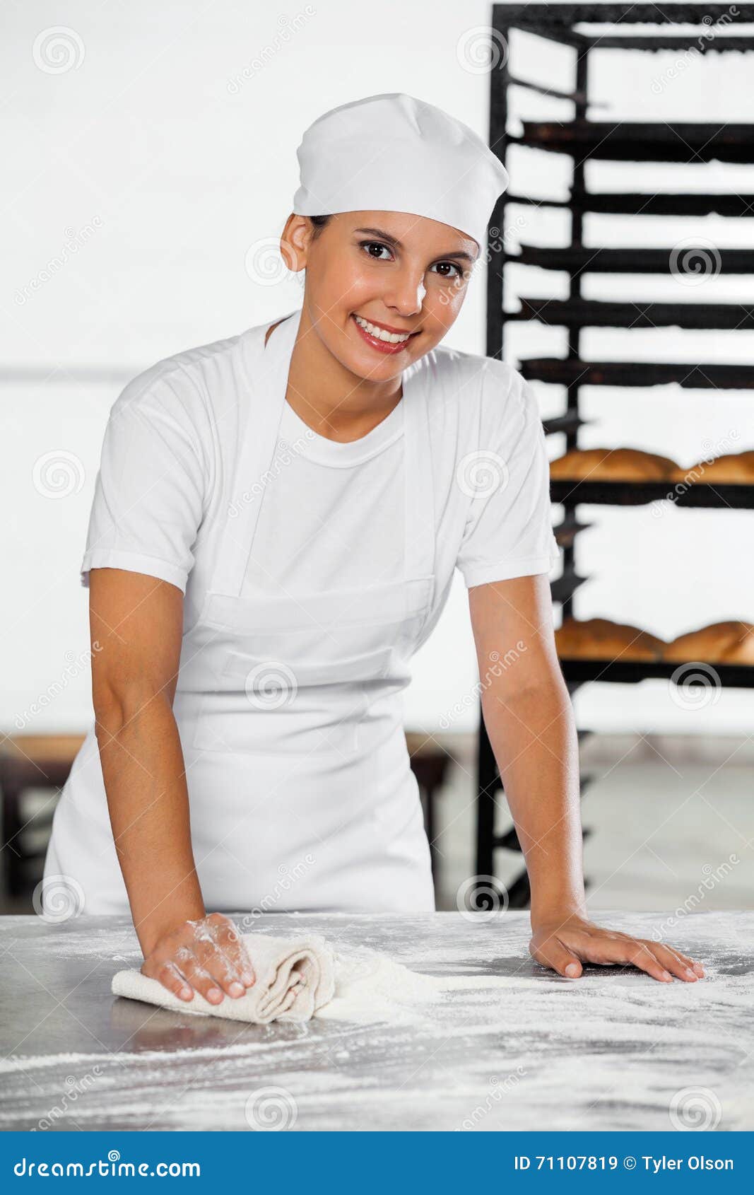 Smiling Female Baker Cleaning Flour from Table Stock Image - Image of ...