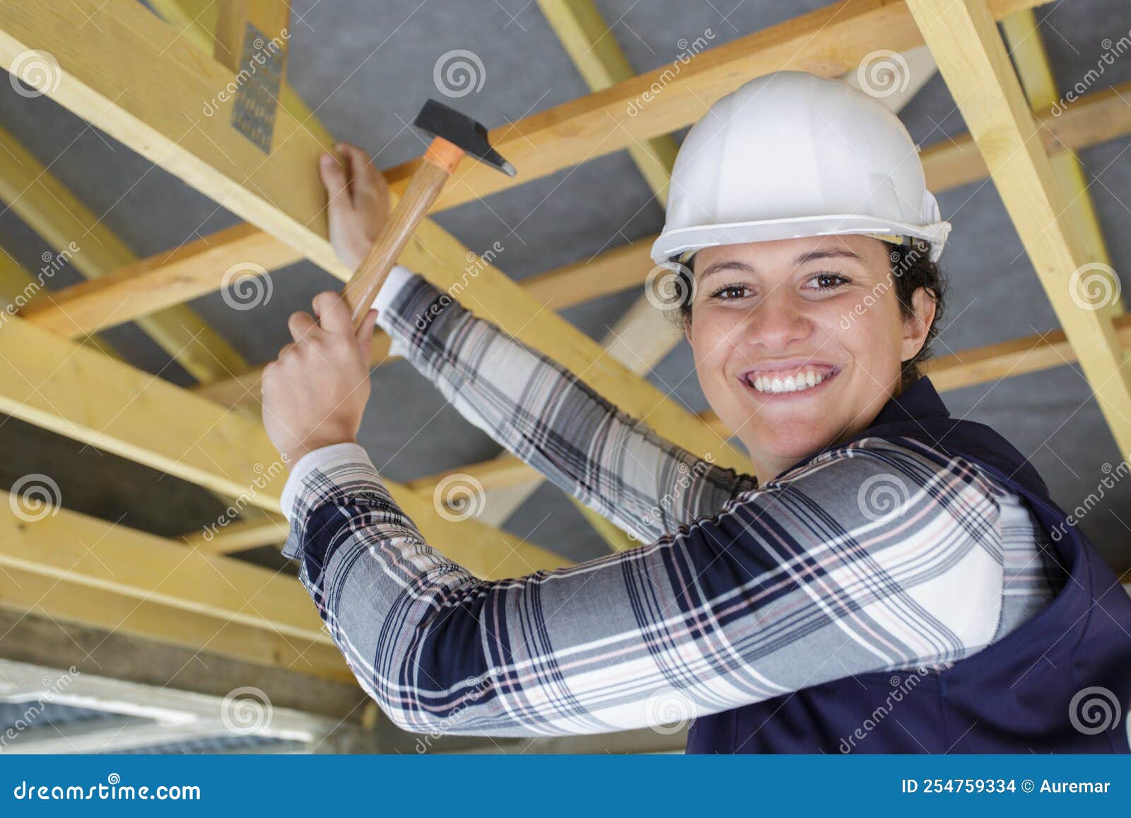 Smiling Female Construction Worker Hammering Nail on Timber Frame Stock ...