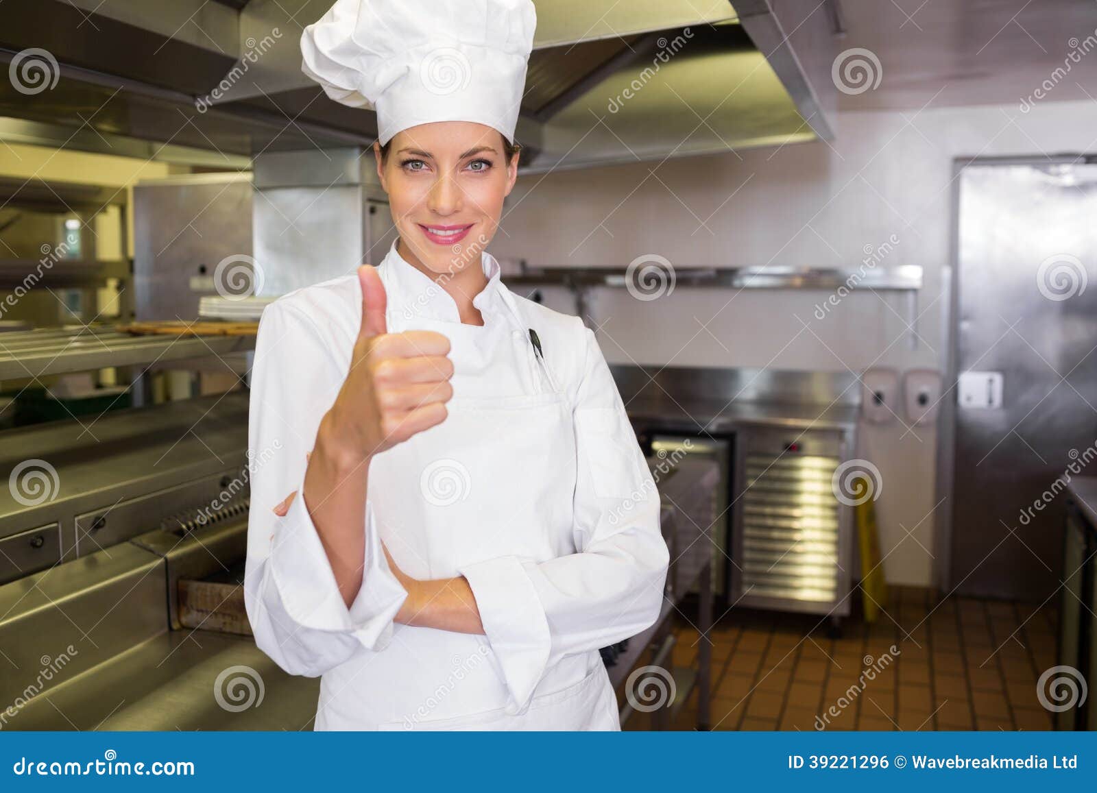 Smiling Female Cook Gesturing Thumbs Up in Kitchen Stock Photo - Image ...