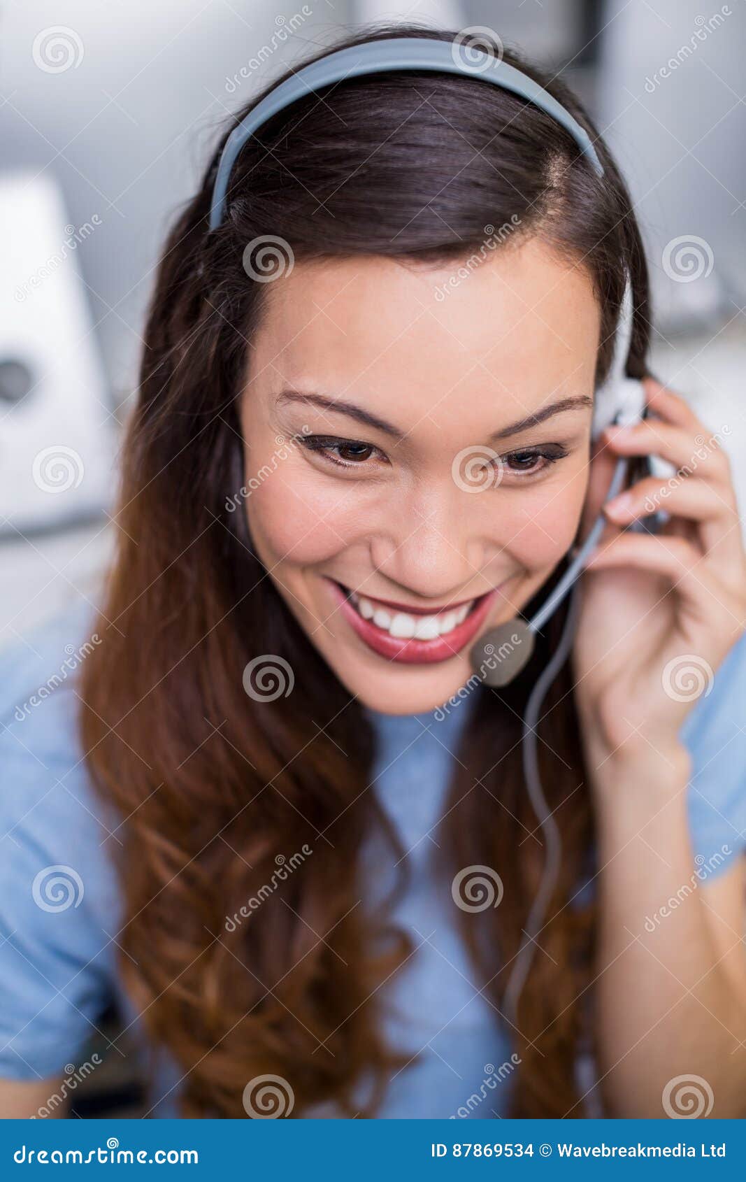 Smiling Female Customer Service Executive Talking on Headset at Desk ... Smiling Female Customer Service Executive Talking on Headset at Desk ...